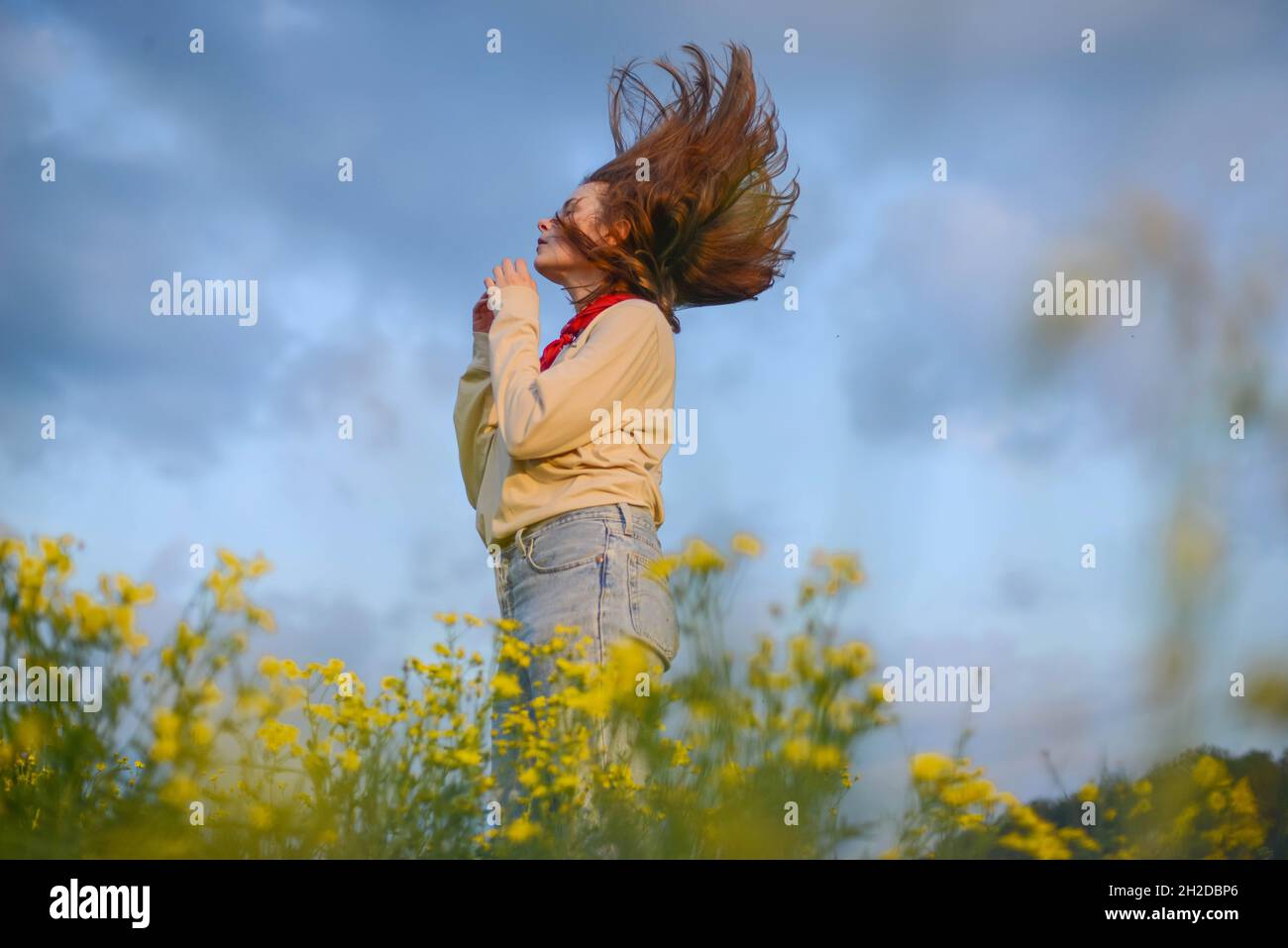 Portrait of confident young woman in field Stock Photo - Alamy