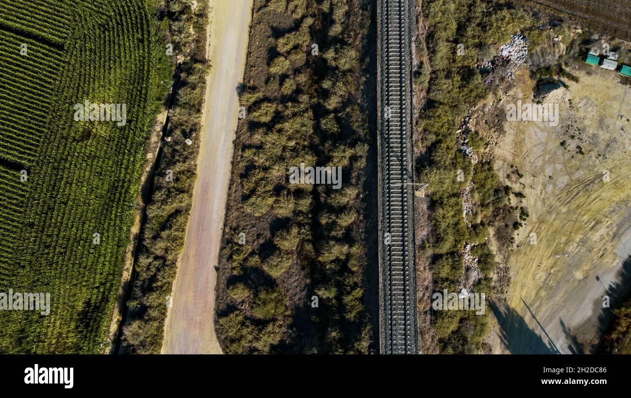 Aerial view of some train tracks next to a road Stock Photo - Alamy