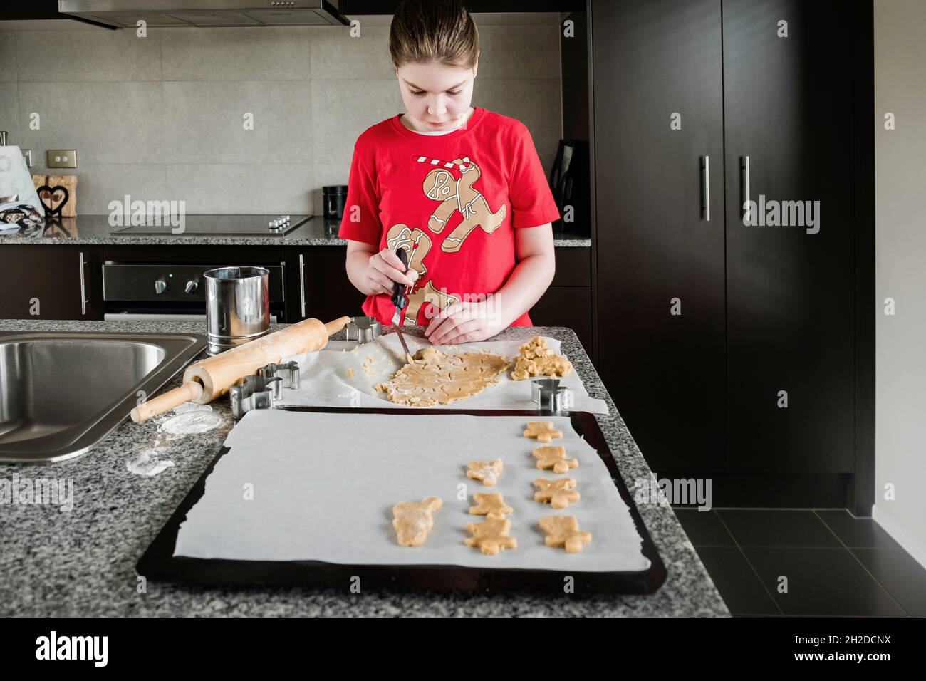 Young girl making gingerbread cookies Stock Photo - Alamy