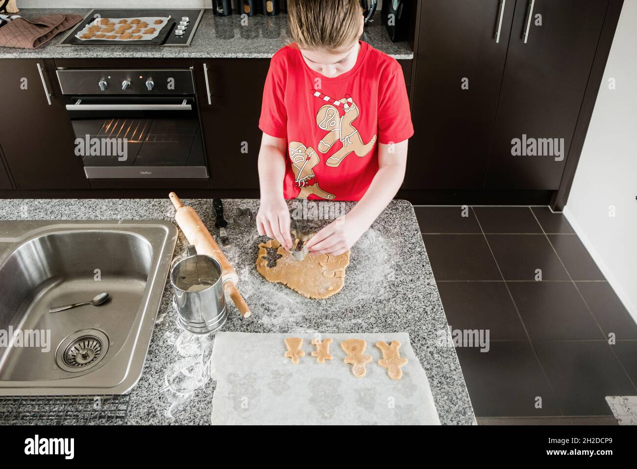 Overhead shot of girl making gingerbread cookies Stock Photo - Alamy
