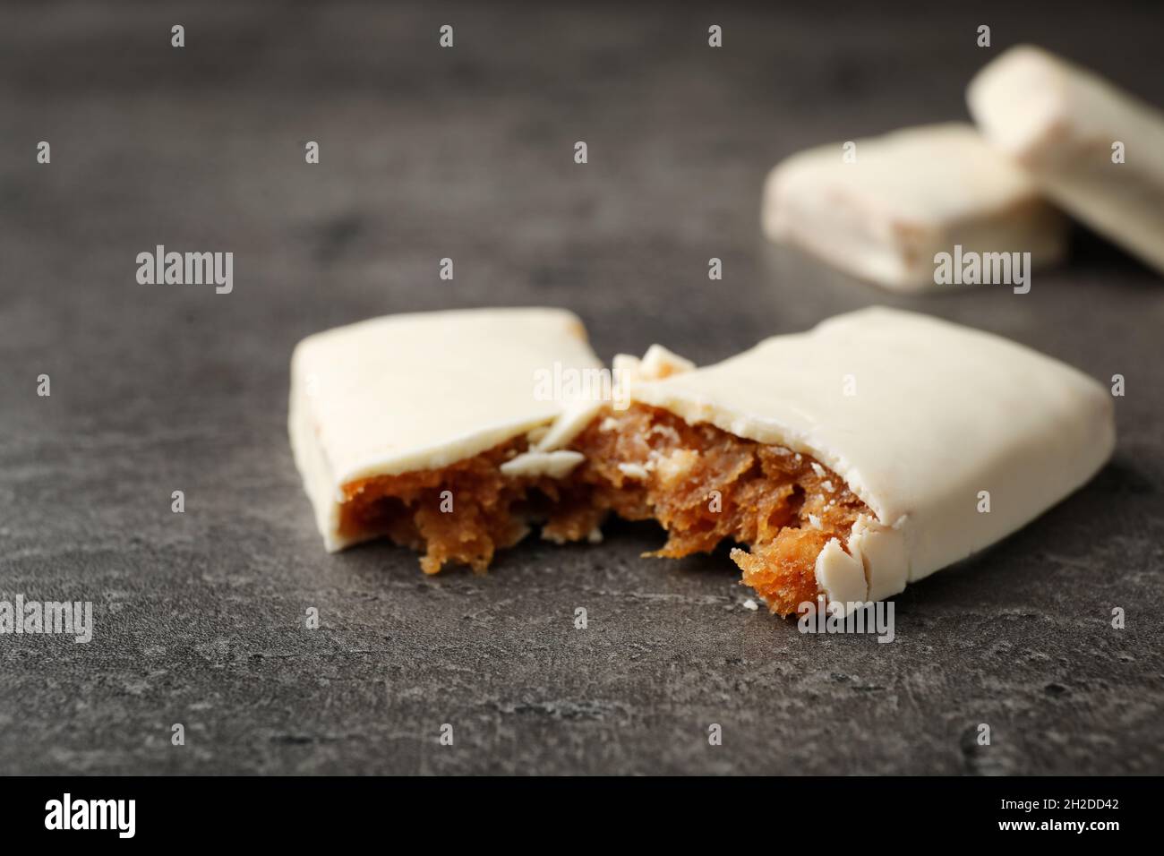 Pieces of tasty protein bar on grey table Stock Photo - Alamy