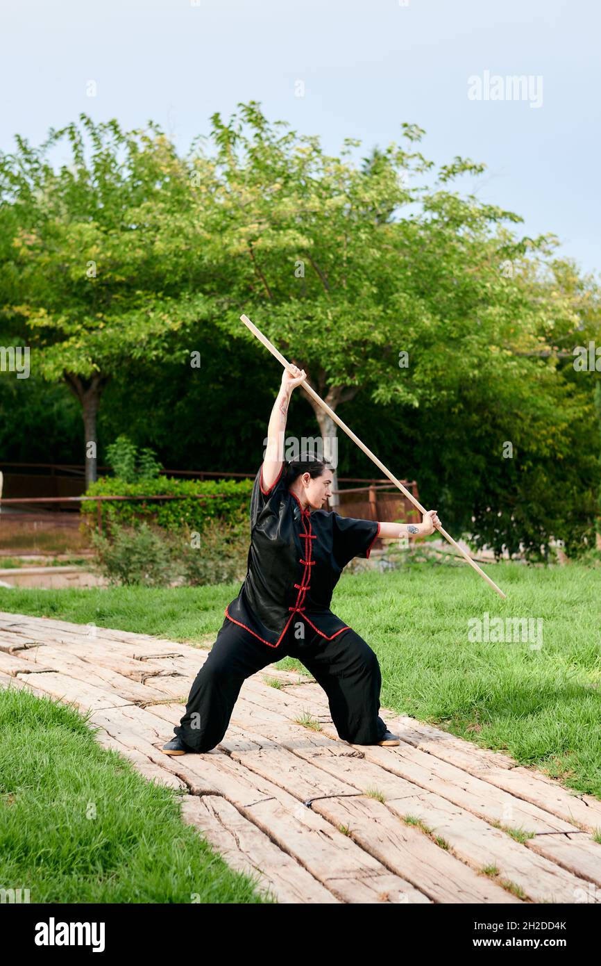 Woman practice kung fu with a stick Stock Photo - Alamy