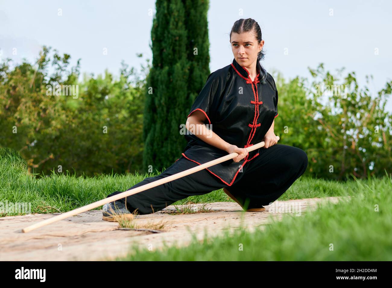 Woman in uniform practicing martial arts with a stick Stock Photo - Alamy