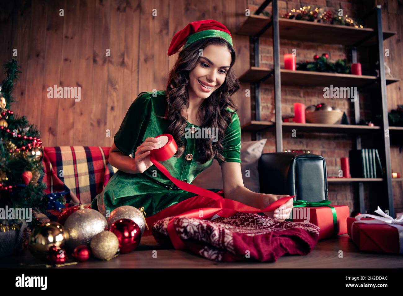 Portrait of attractive cheerful girl elf wrapping ugly pullover eve ...