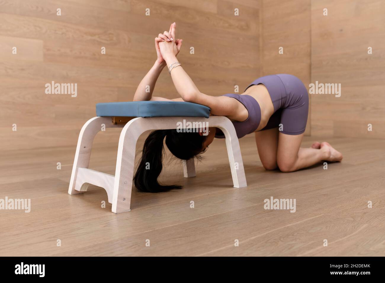 Asian yogi woman is practicing yoga on a feet up stool Stock Photo - Alamy
