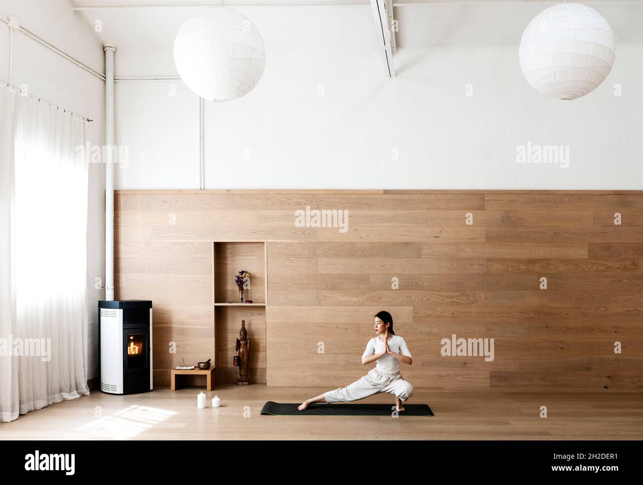 flexible female practicing yoga and performing Side Lunge pose Stock ...