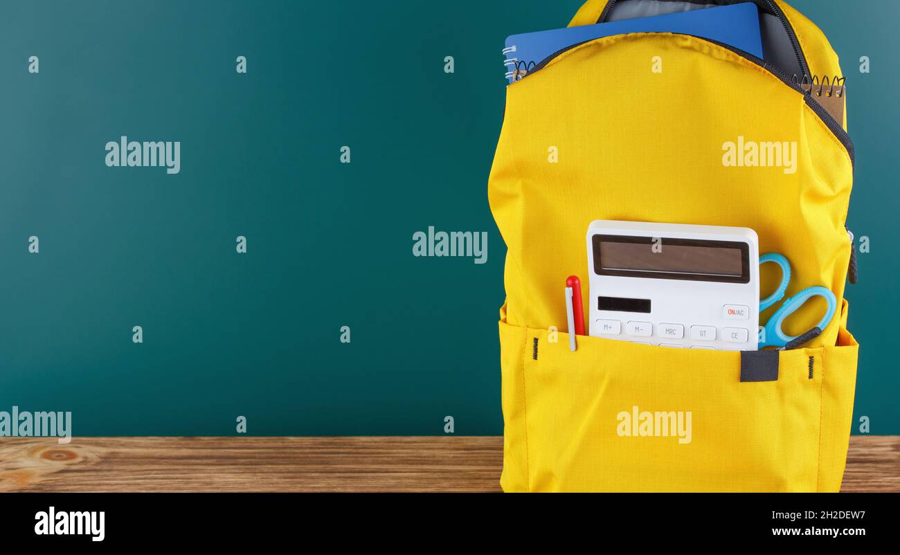 Backpack on the desk in the classroom Stock Photo - Alamy