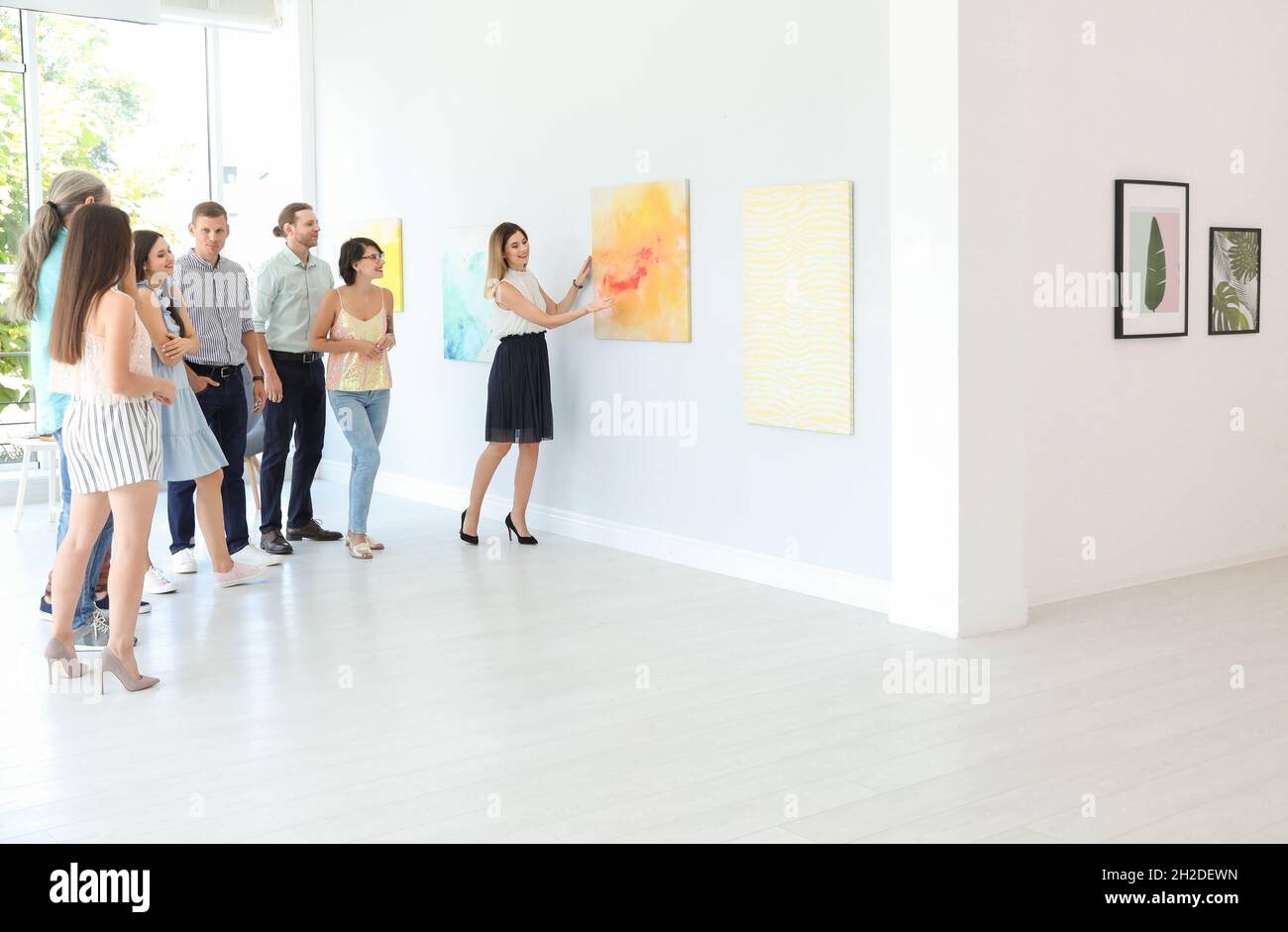 Group of people with guide at exhibition in art gallery Stock Photo - Alamy