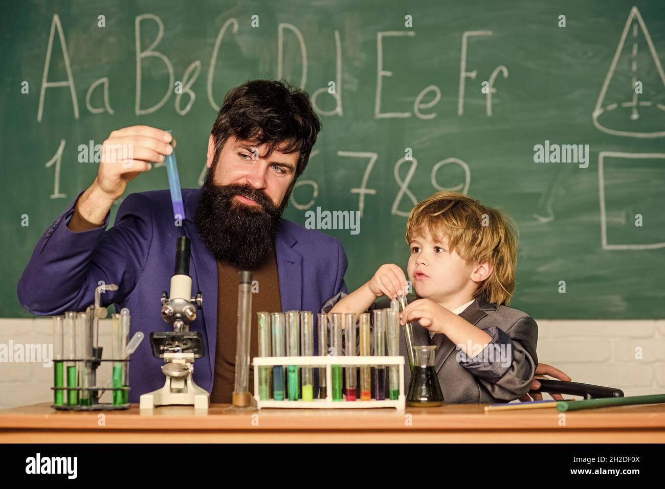 Taking You Forward. small boy with teacher man. Biologist Conducts ...