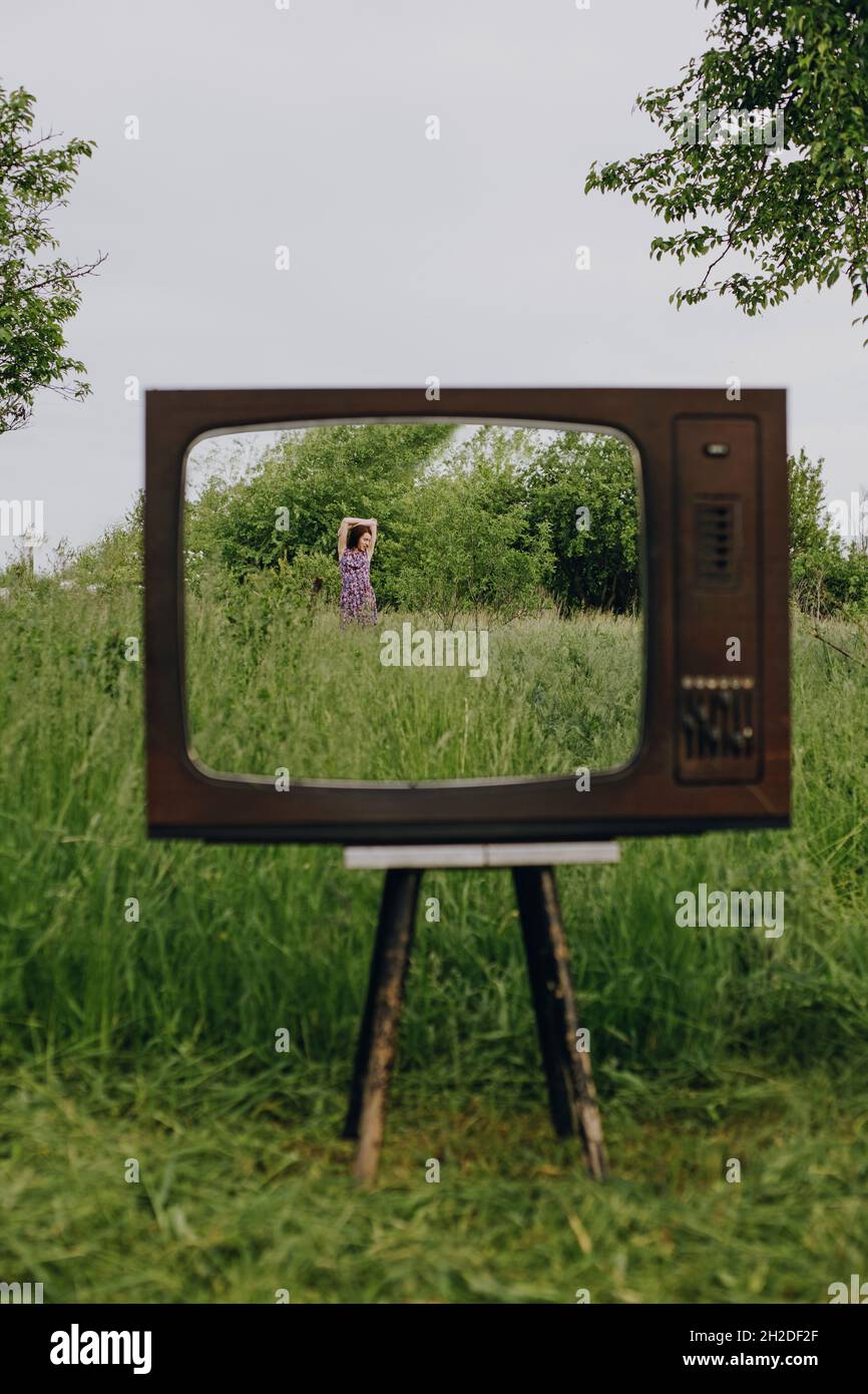 Girl walk in garden in old television frame outdoors, mental health ...