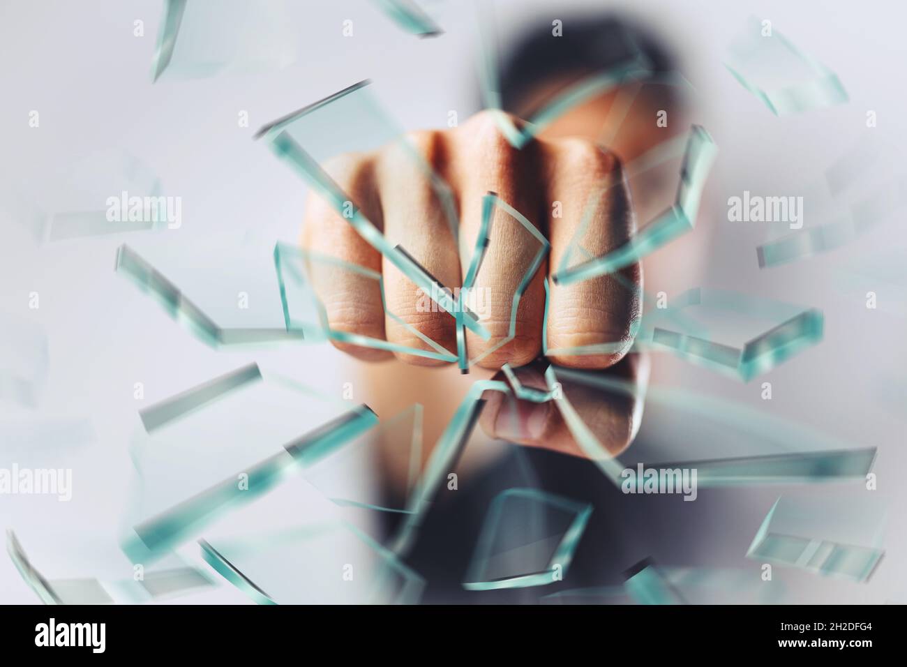 close up of a man's fist punching and breaking glass to pieces - Home ...