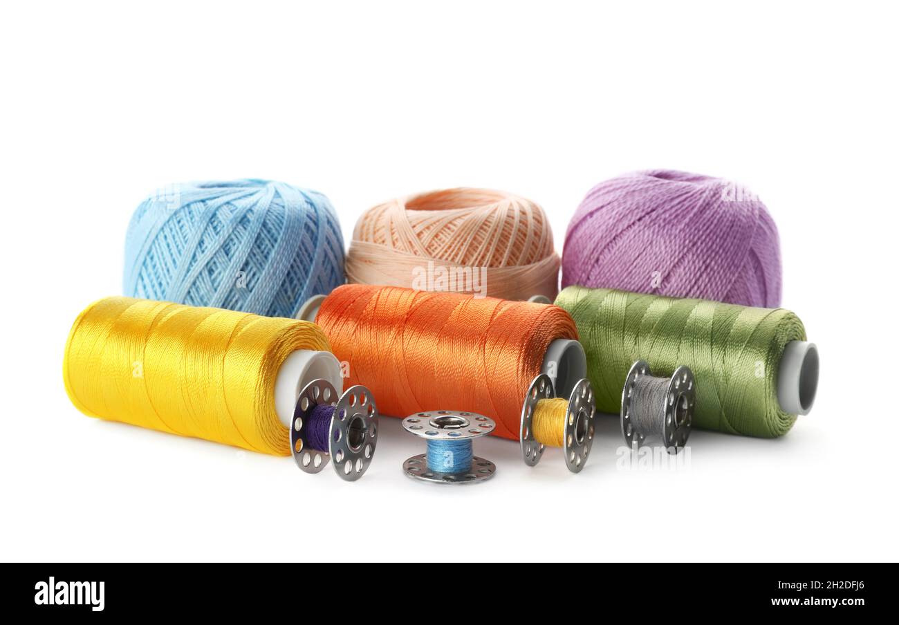 Color sewing threads on white background Stock Photo - Alamy