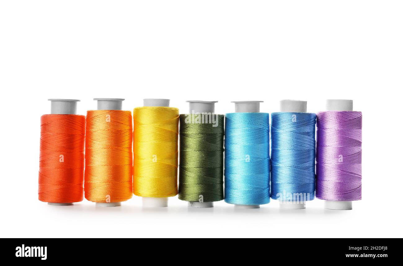 Color sewing threads on white background Stock Photo - Alamy