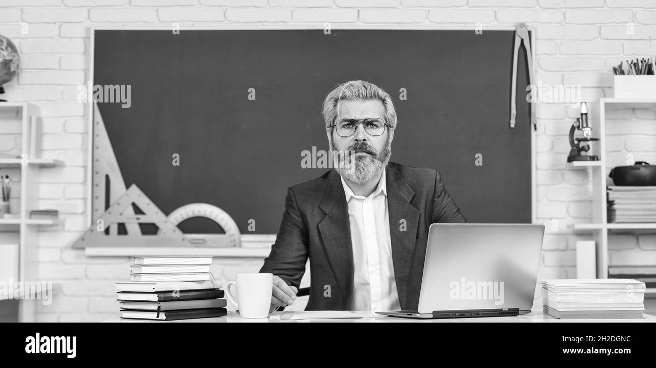 Selecting specific courses. School teacher programming laptop. Learn ...