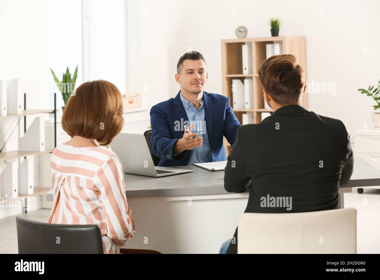 Human resources manager conducting job interview with applicants in ...