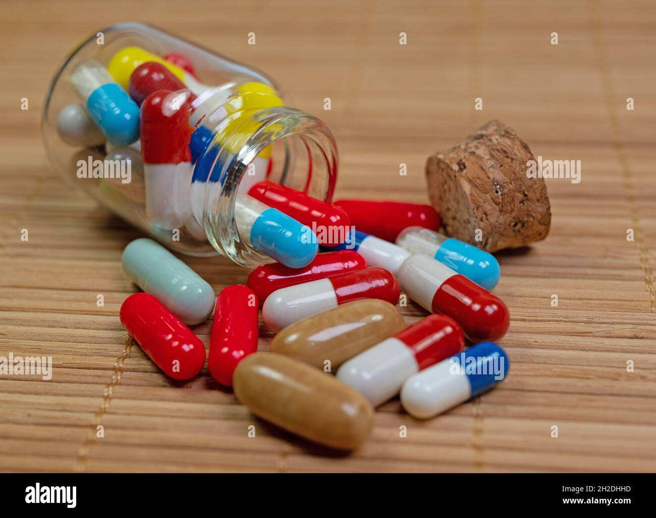 Many colorful capsules as medicine in a glass bottle Stock Photo - Alamy