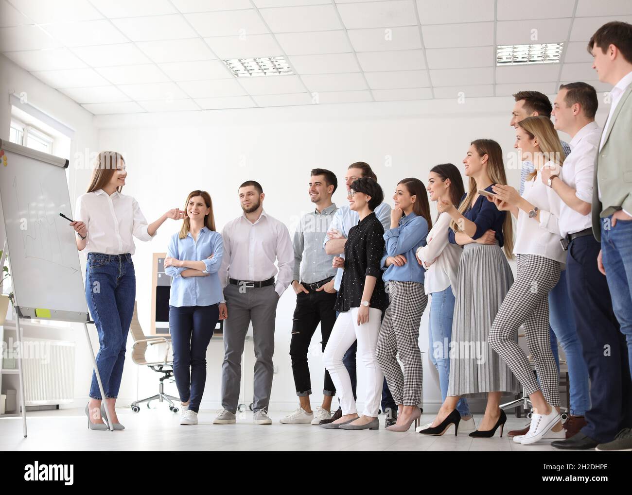 Female business trainer giving lecture in office Stock Photo - Alamy