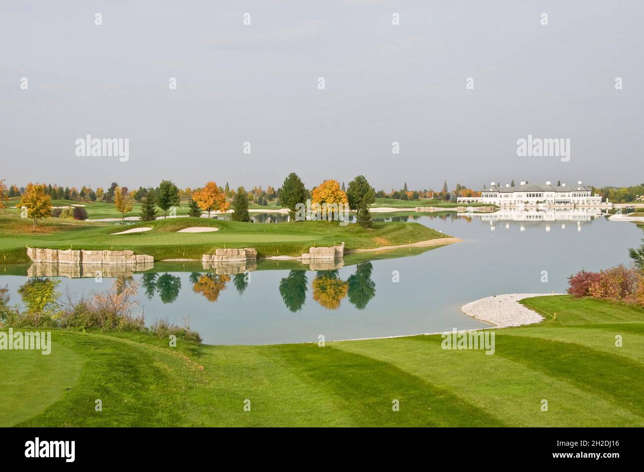 Autumnal view to a golf course with artificial pond Stock Photo - Alamy