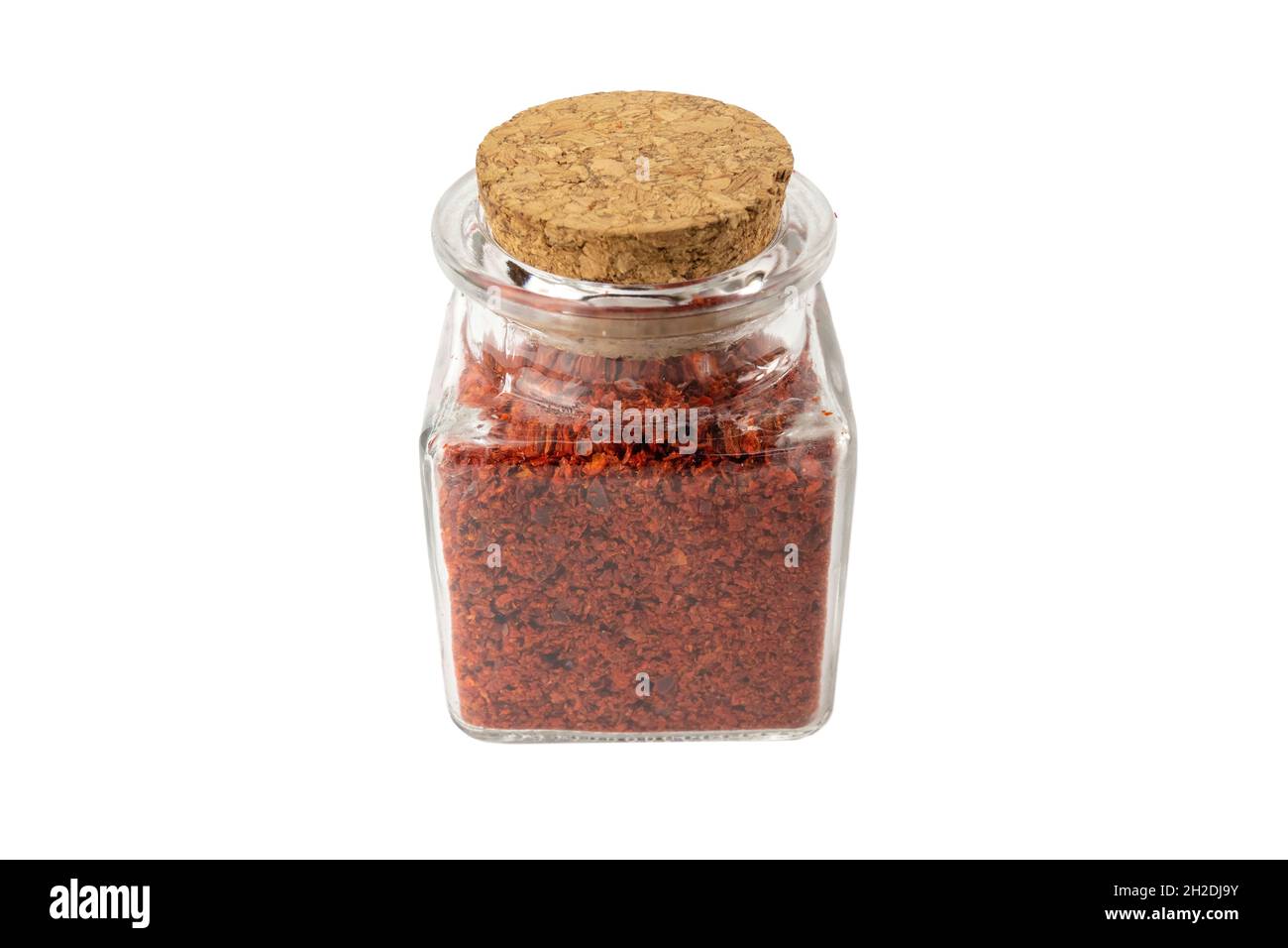 chilli pepper seedless flakes in a glass jar isolated on white ...