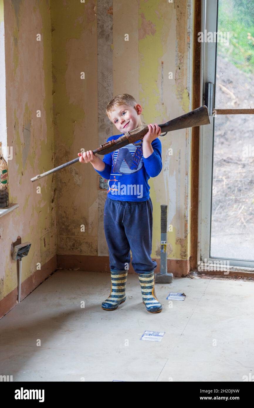 Five year old boy playing with an old hunting rifle, High Bickington ...