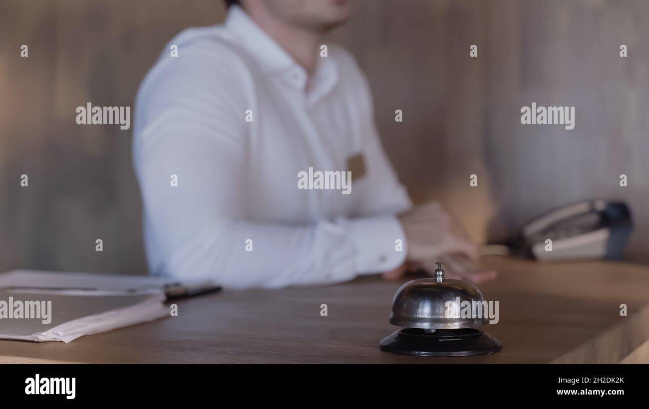 cropped view of hotel receptionist at hotel counter Stock Photo - Alamy