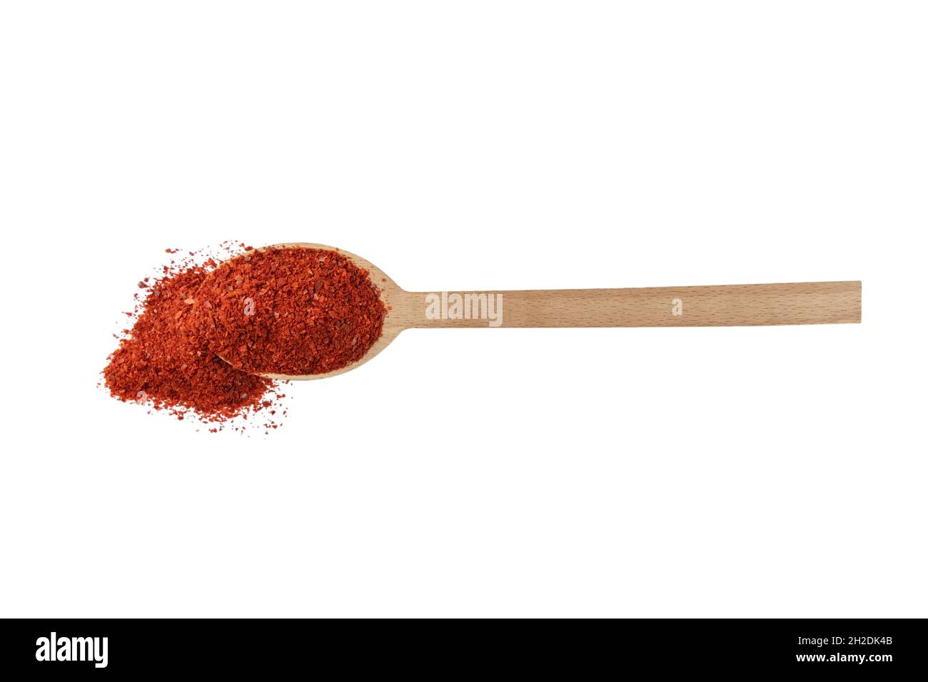 chilli pepper seedless flakes in wooden spoon isolated on white ...