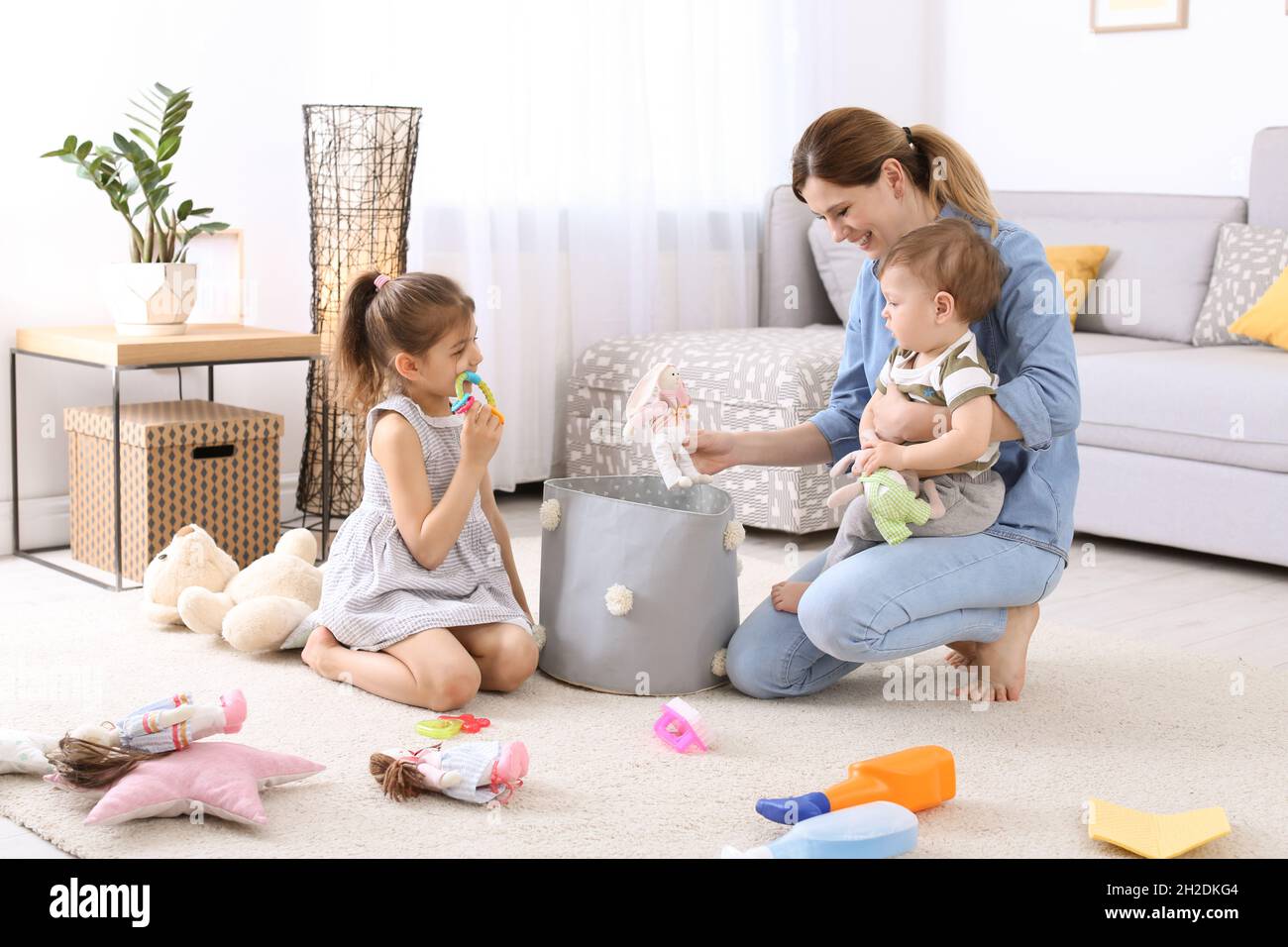 Boy cleaning up toys hi-res stock photography and images - Alamy