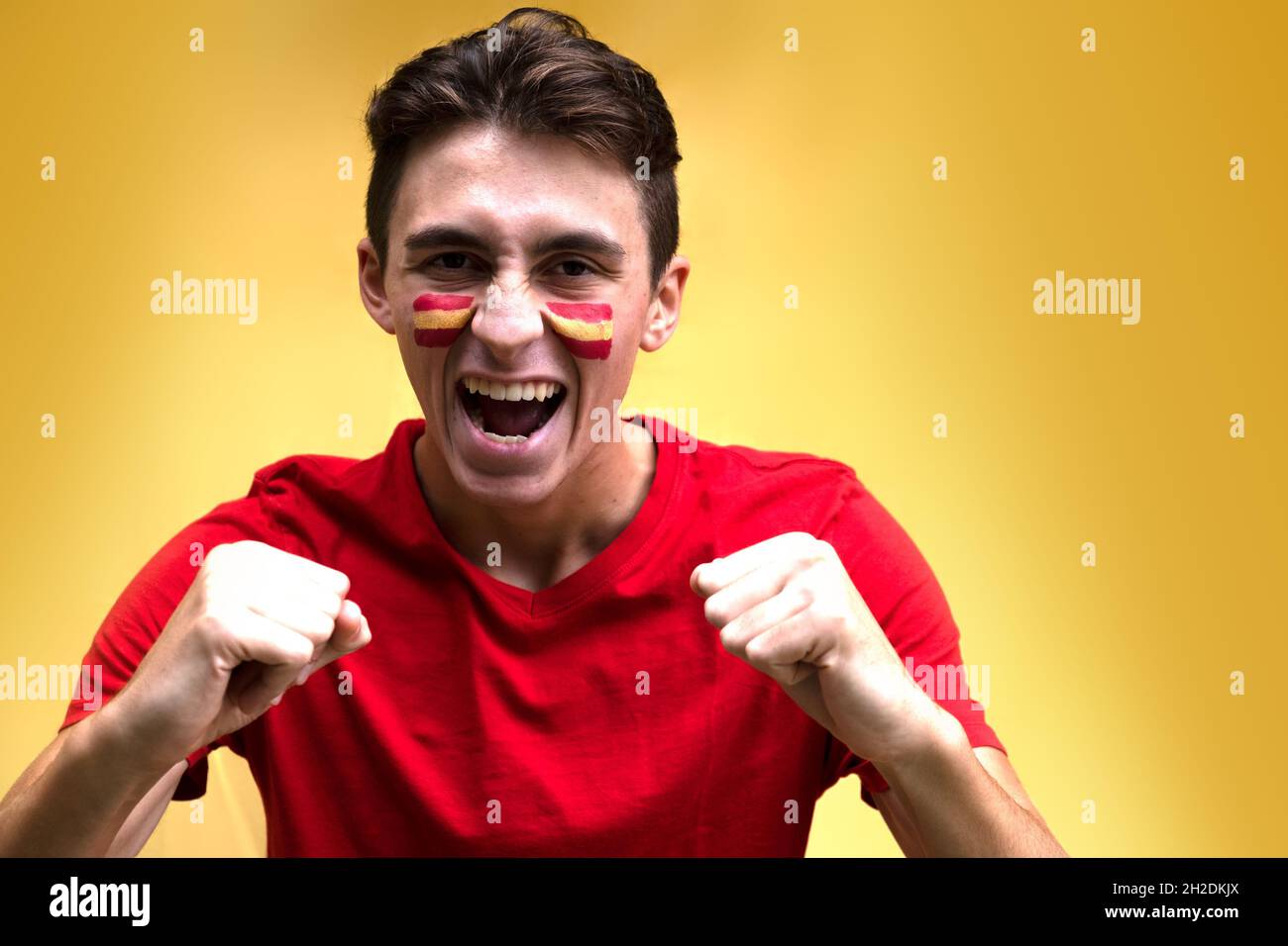 Spanish football fan happy for his national team, isolated on yellow ...