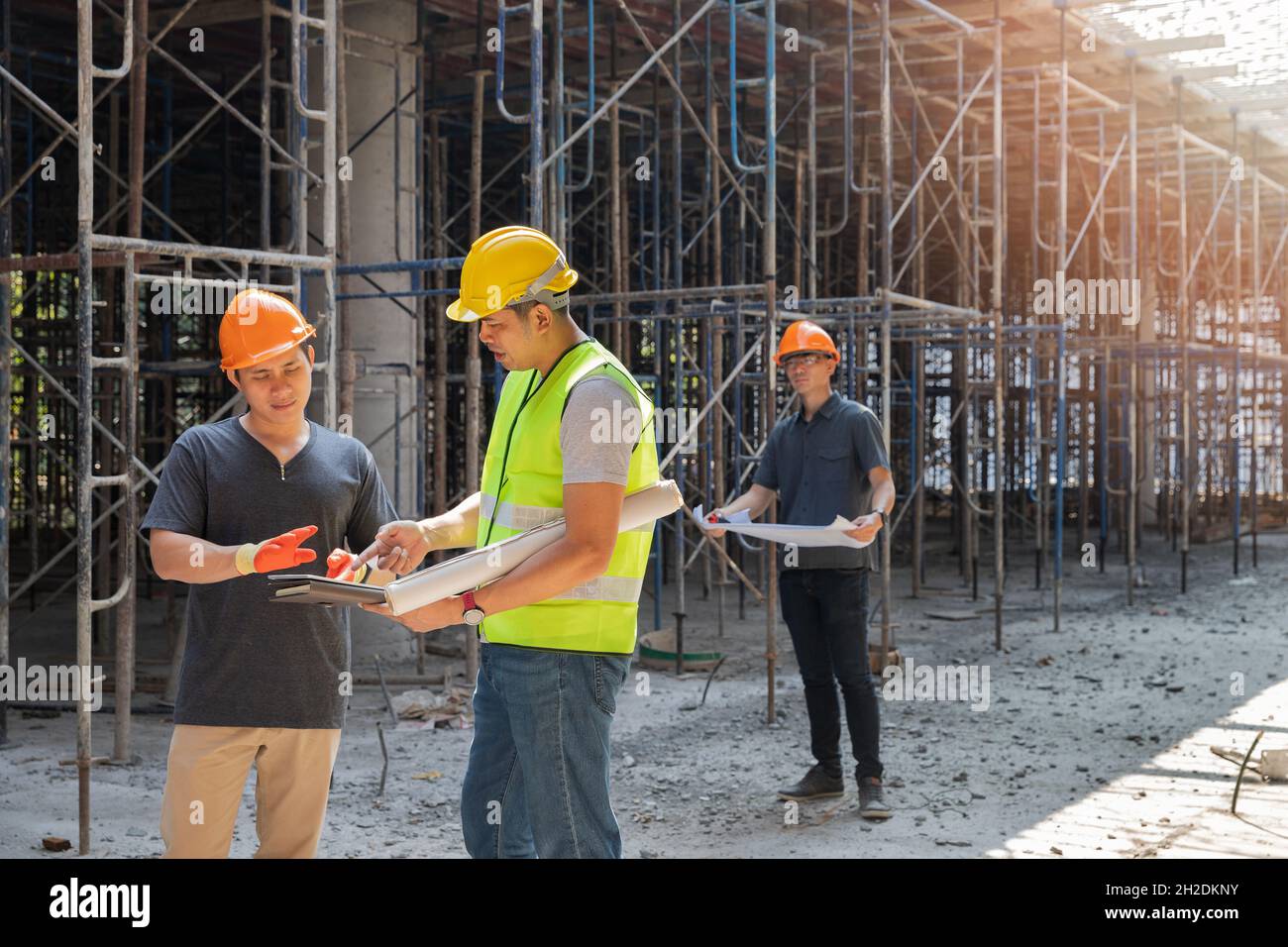 Engineer discussing with foreman about project in building construction ...