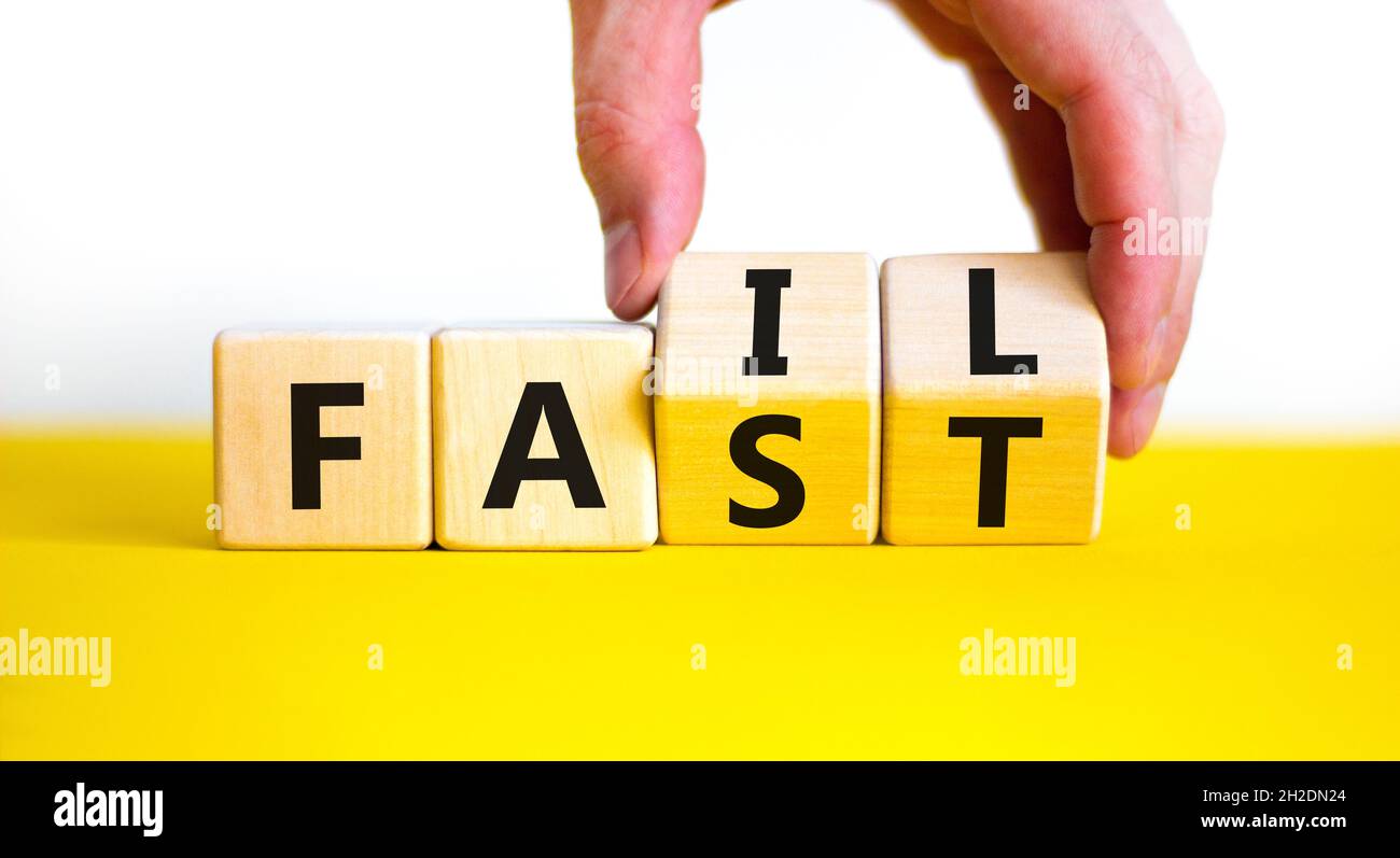 Fail fast symbol. Businessman turn wooden cubes with words 'fail fast ...