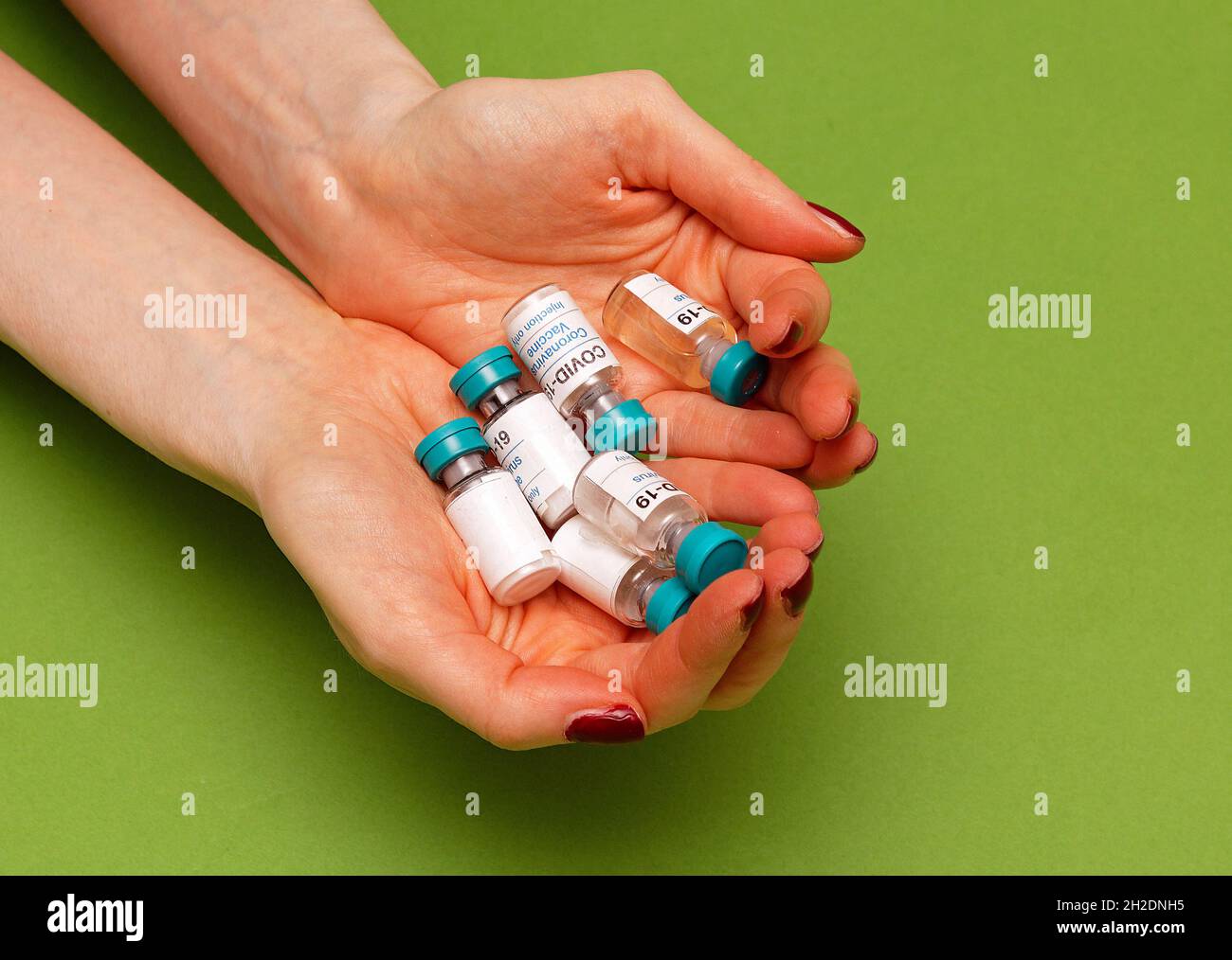 Female medical worker holding coronavirus vaccines in her hands without ...