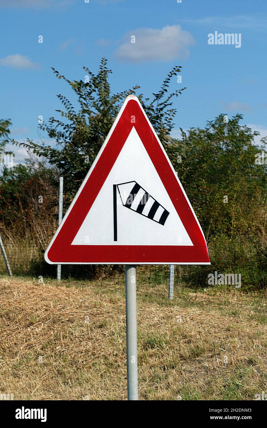 Warning traffic sign for strong wind inside white triangle outside on ...