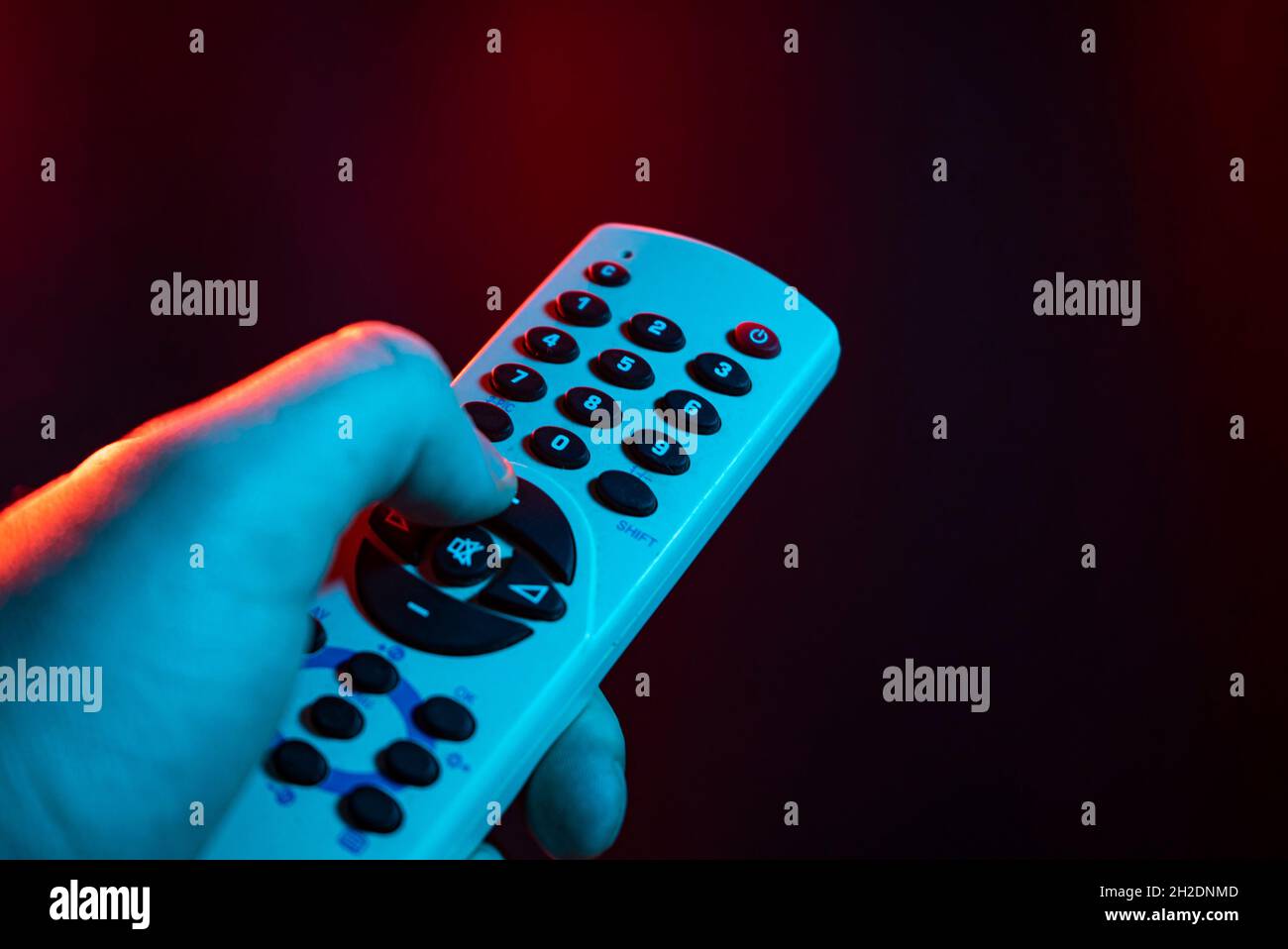 Hold remote control in hand and zap. Male hand is holding TV remote ...