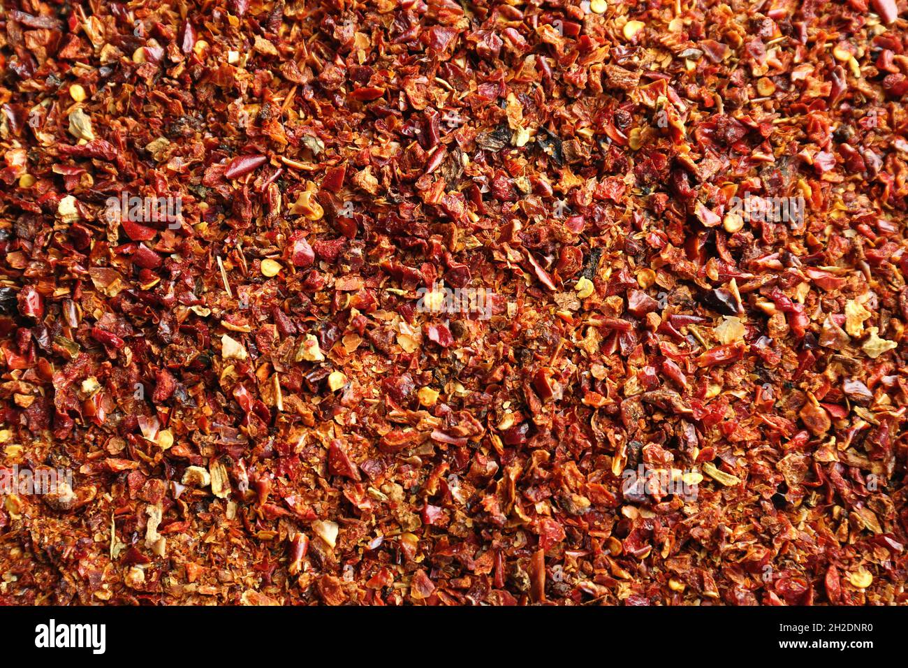 Crushed chili pepper as background Stock Photo - Alamy