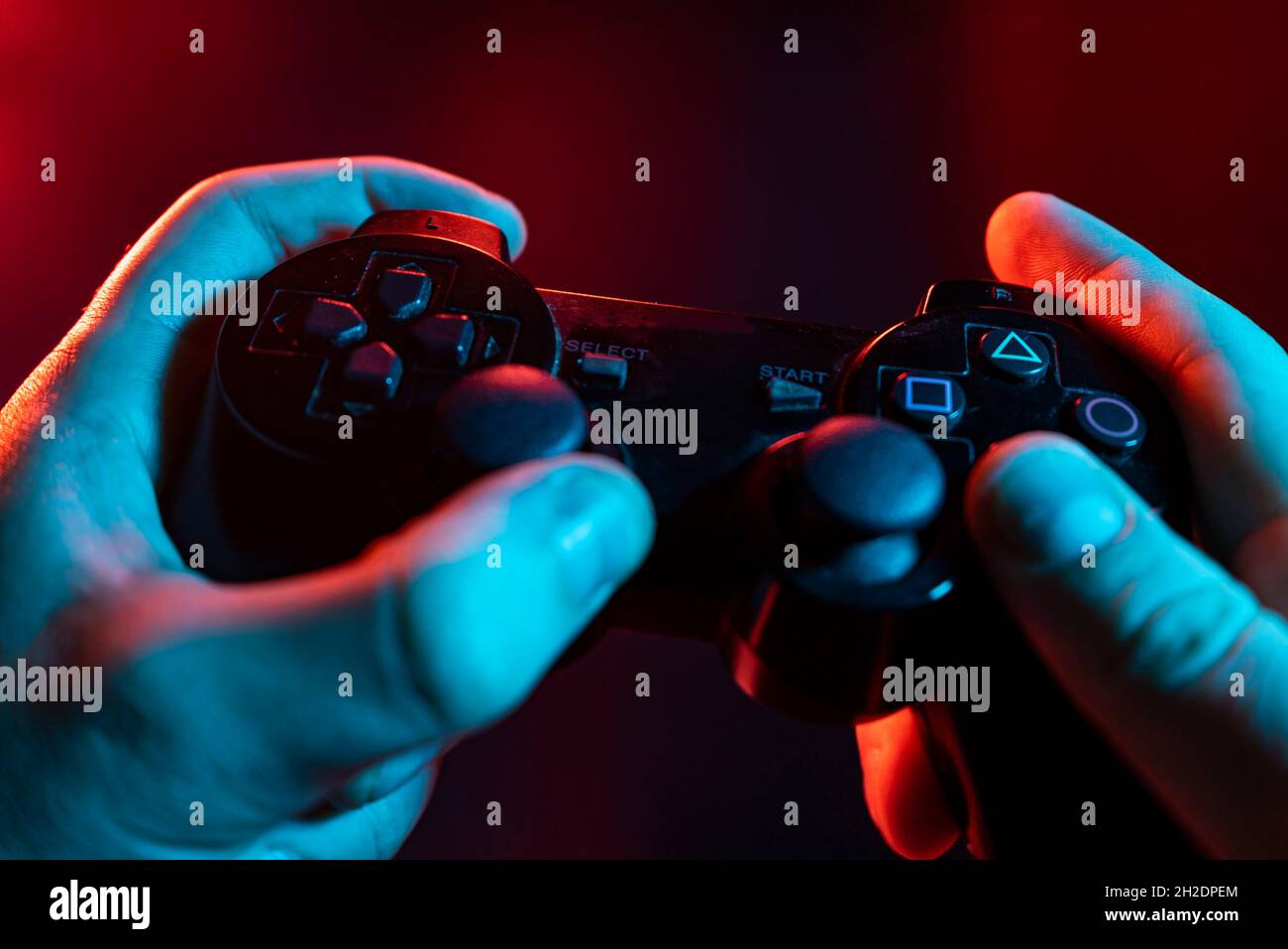 Close up of male hands playing the video game at night with joystick in ...