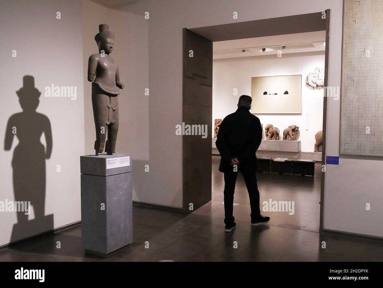 Paris, France. 21st Oct, 2021. A visitor walks past a piece of artwork ...
