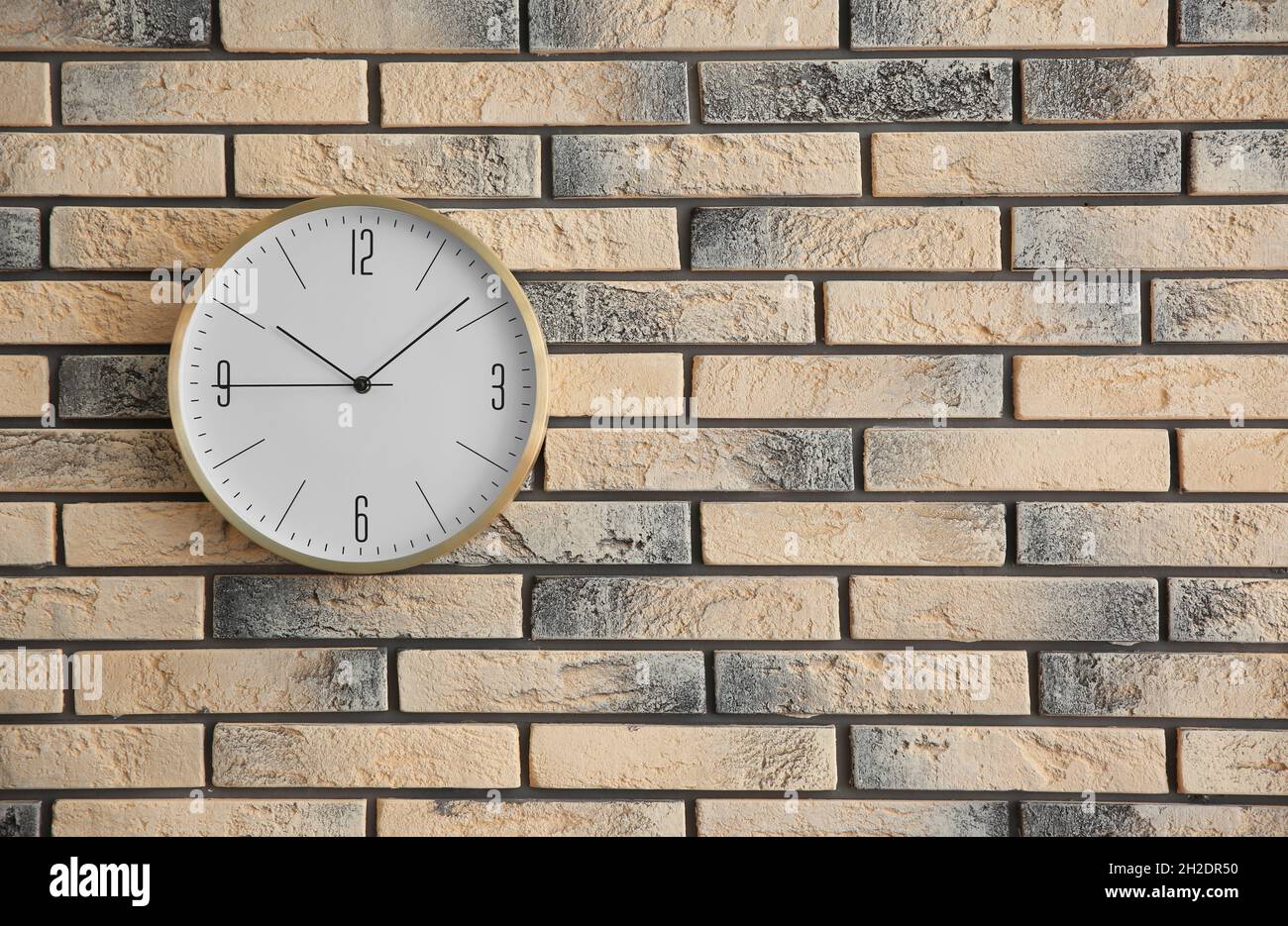 Stylish clock on brick wall. Time concept Stock Photo - Alamy
