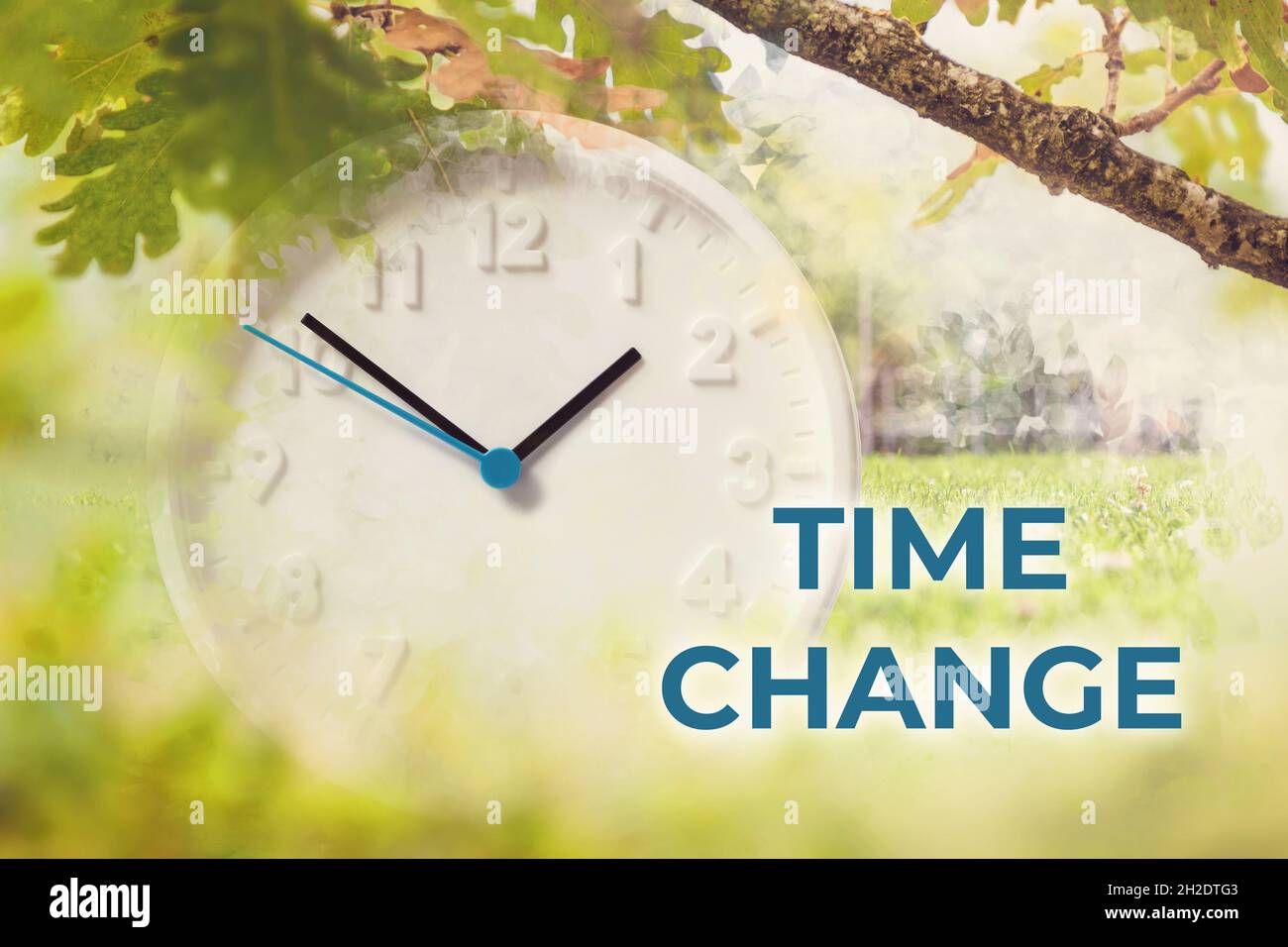 Time change. Clocks and leaves on a wooden table with acorns. Daylight ...
