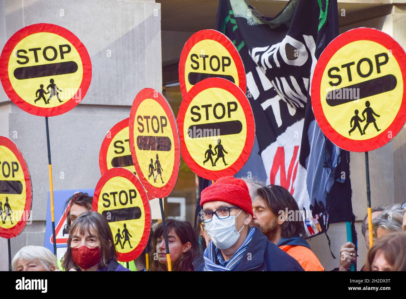 Protesters hold 'Stop' lollipop signs during the demonstration ...