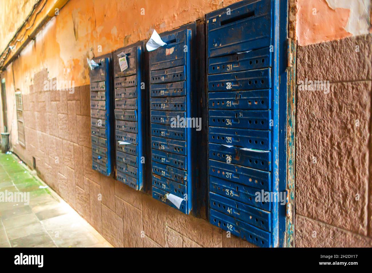 A wall with rows of mailboxes in a multi-storey residential building ...