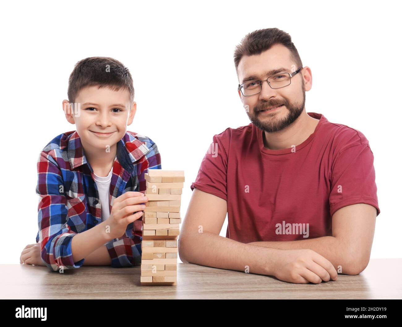 Little boy and his dad playing board game on white background Stock ...