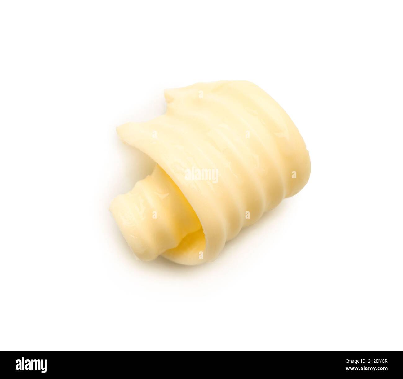 Fresh butter curl on white background Stock Photo - Alamy