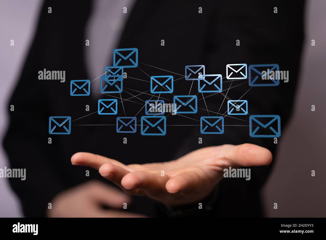 Male hand holding email icons on his palm-communication and feedback ...