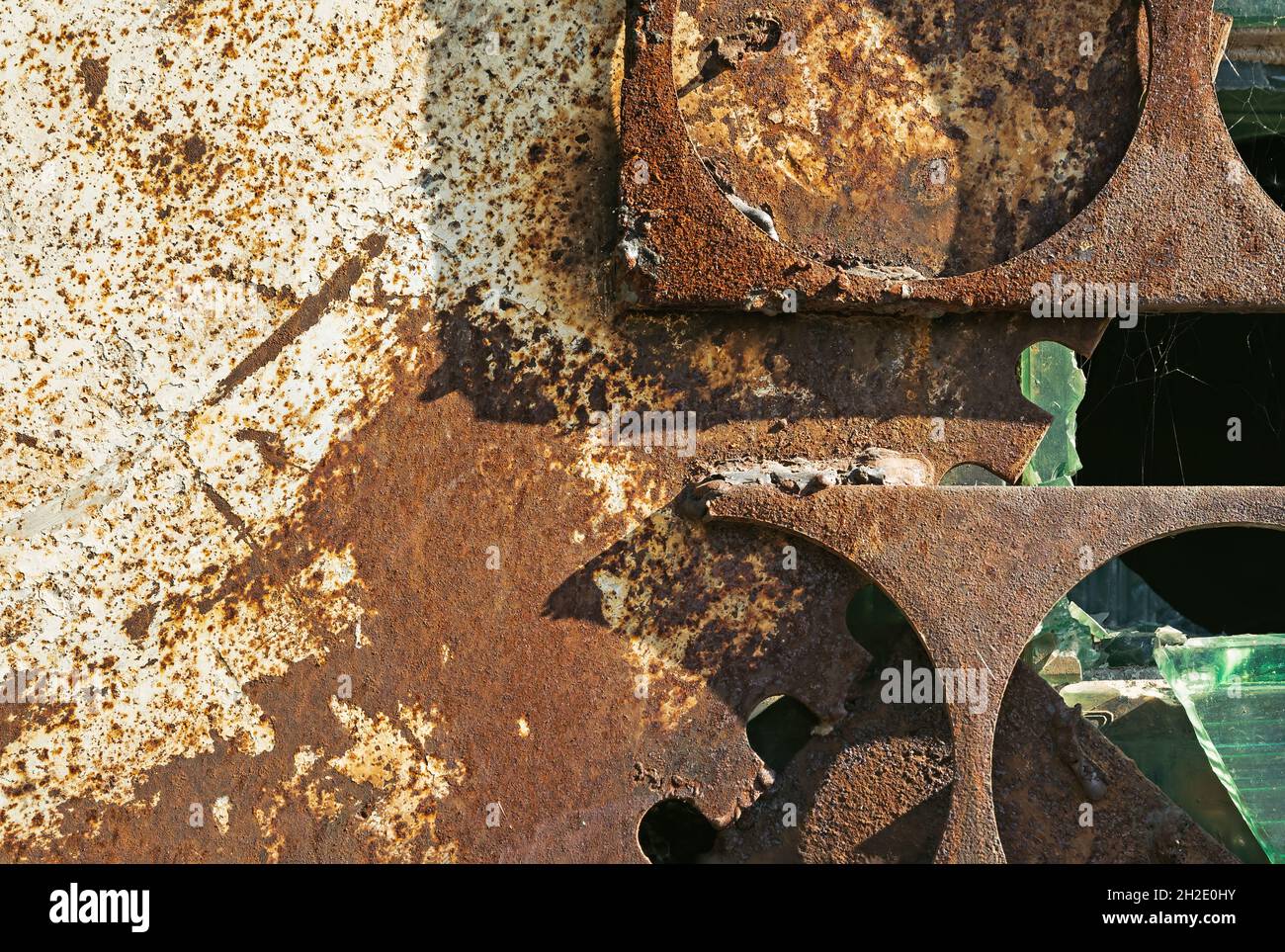 Wall of an old industrial building with broken glass panels and rusty ...