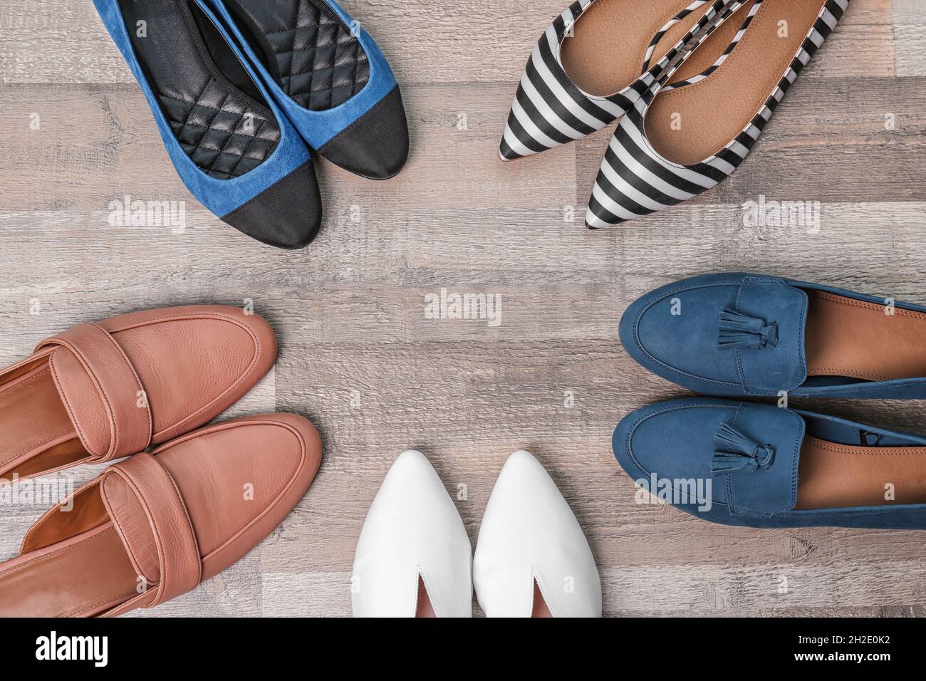 Different female shoes on wooden background, top view Stock Photo - Alamy