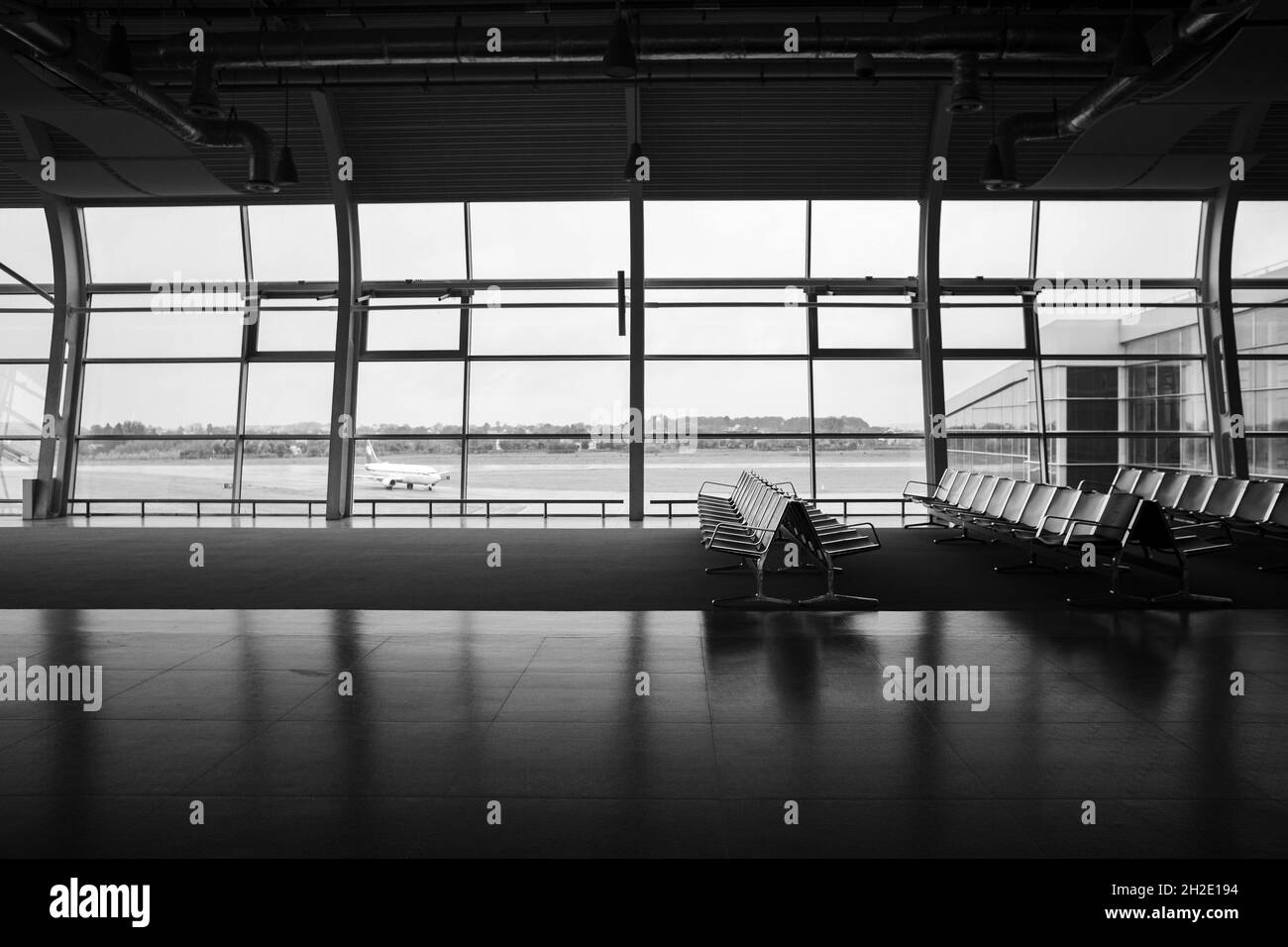 Deserted airport terminal. Rows of empty seats in the waiting room ...