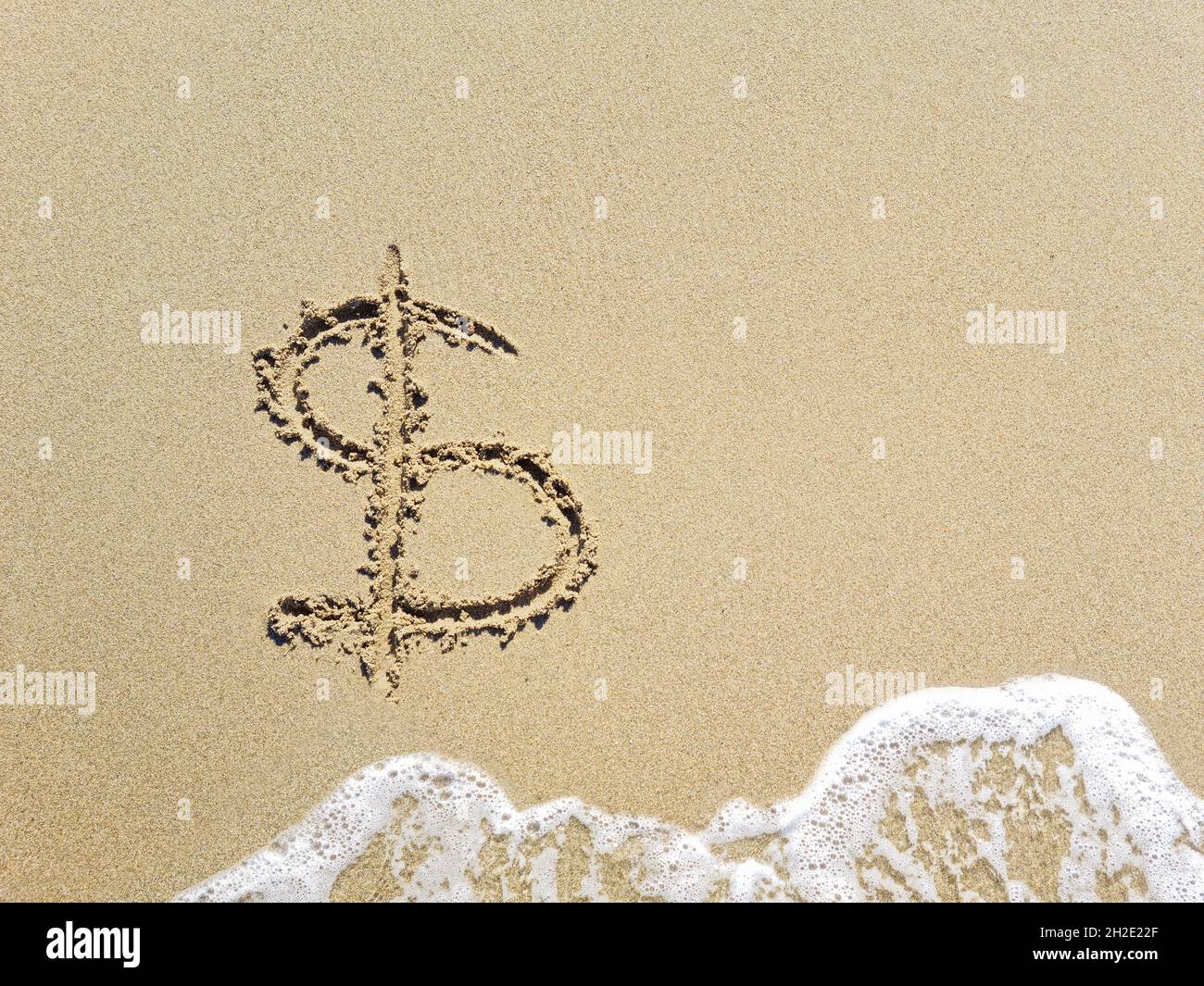 Dollar in sand hi-res stock photography and images - Alamy