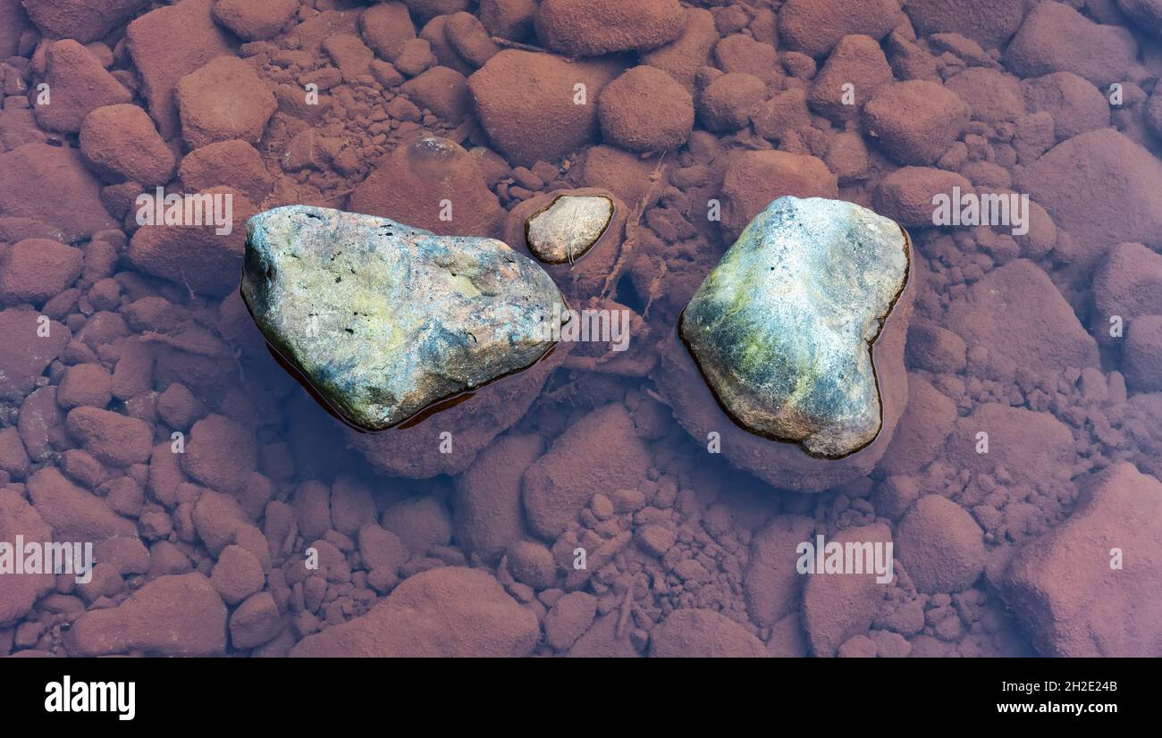 Water running down the river around rocks Stock Photo - Alamy