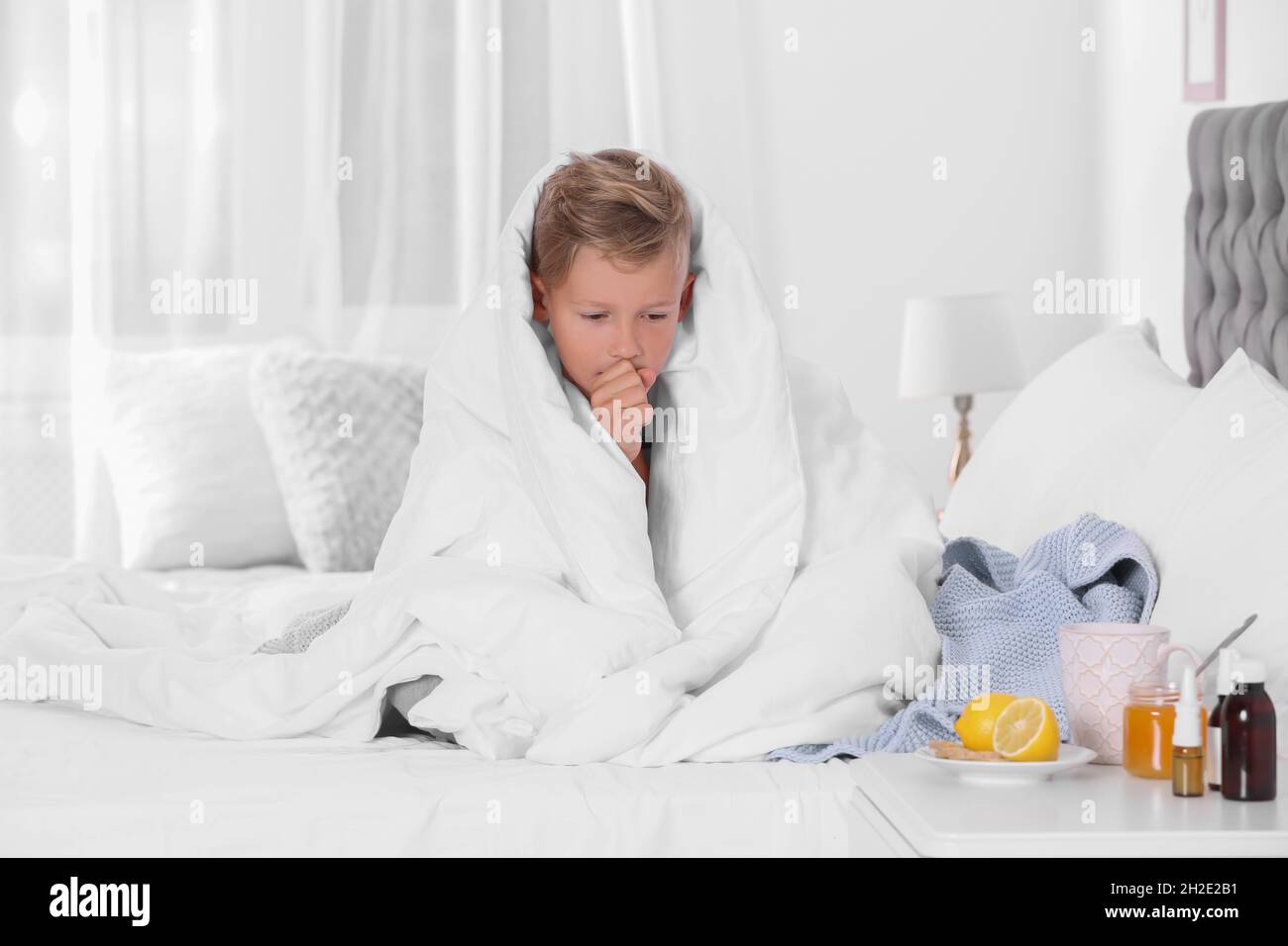 Ill boy suffering from cough at home Stock Photo - Alamy