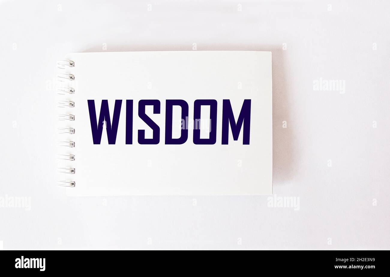 Wisdom word written on notepad and white background Stock Photo - Alamy